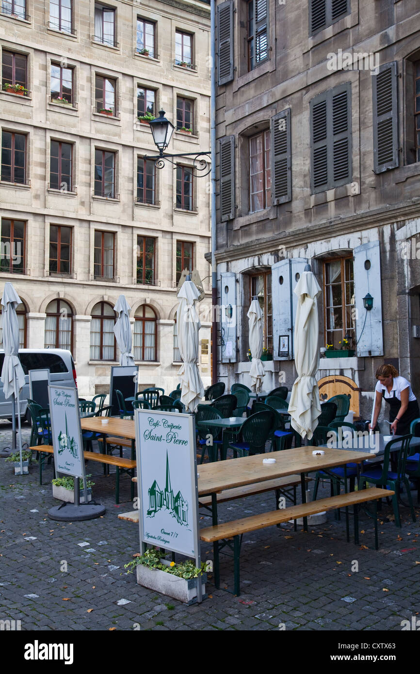 A woman cleaning the eating area of an outdoor Creperie, Geneva ...