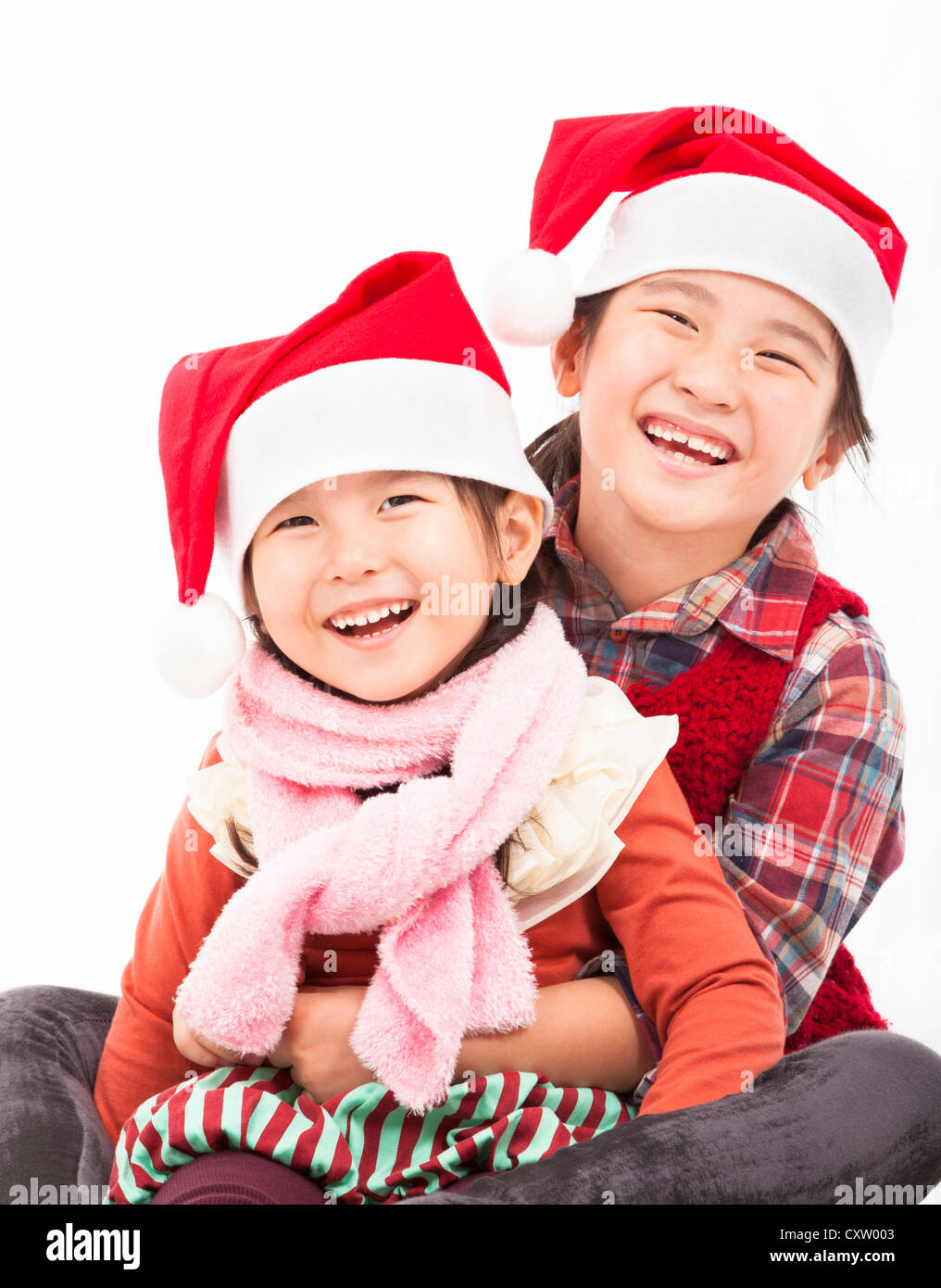 Two girls christmas hat presents hi-res stock photography and images ...