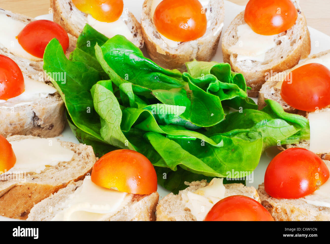 Canapes with cheese, tomatoes and salad Stock Photo - Alamy