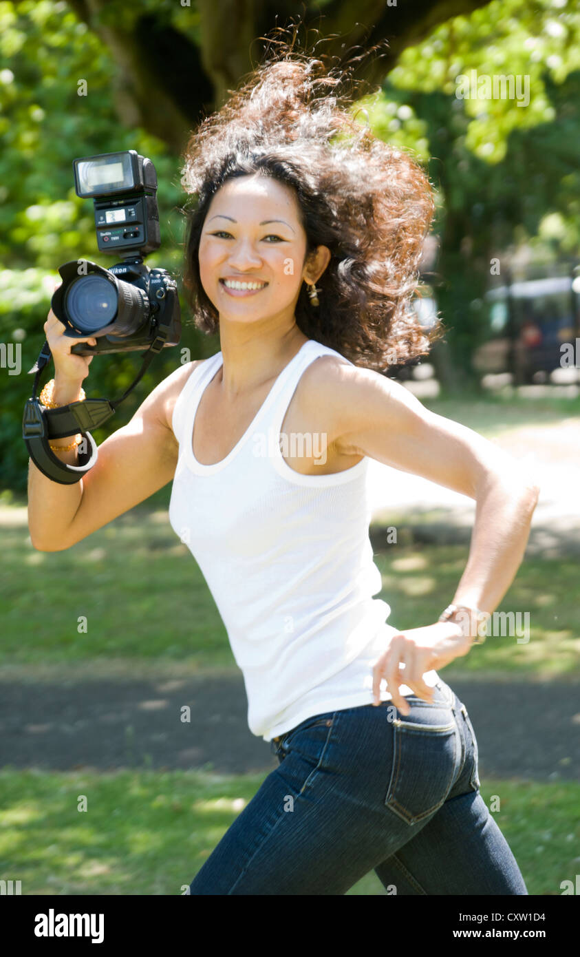 Asian young woman running with Digital SLR Camera - Kit Model released ...
