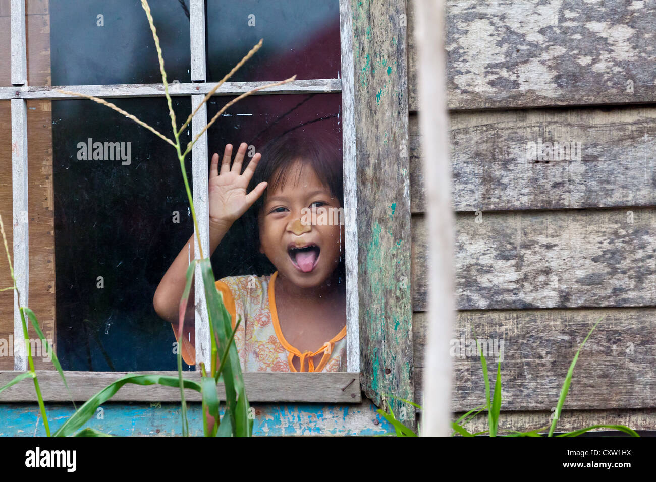 Little Girl behind a Window Glass in Banjarmasin, Indonesia Stock Photo ...