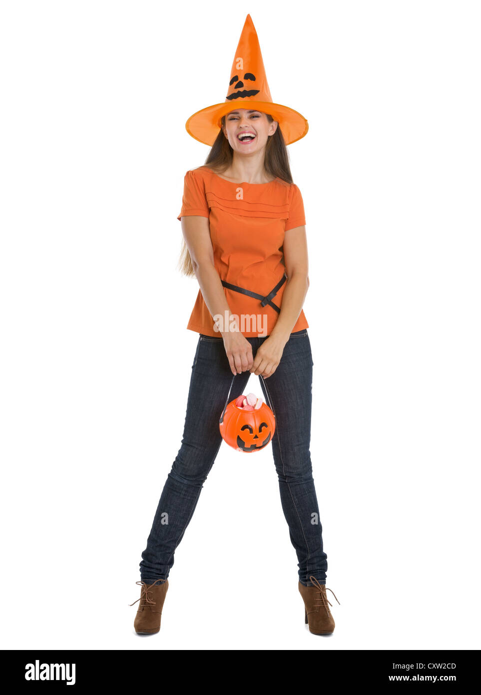 Happy woman holding Halloween bucket with sweets Stock Photo - Alamy