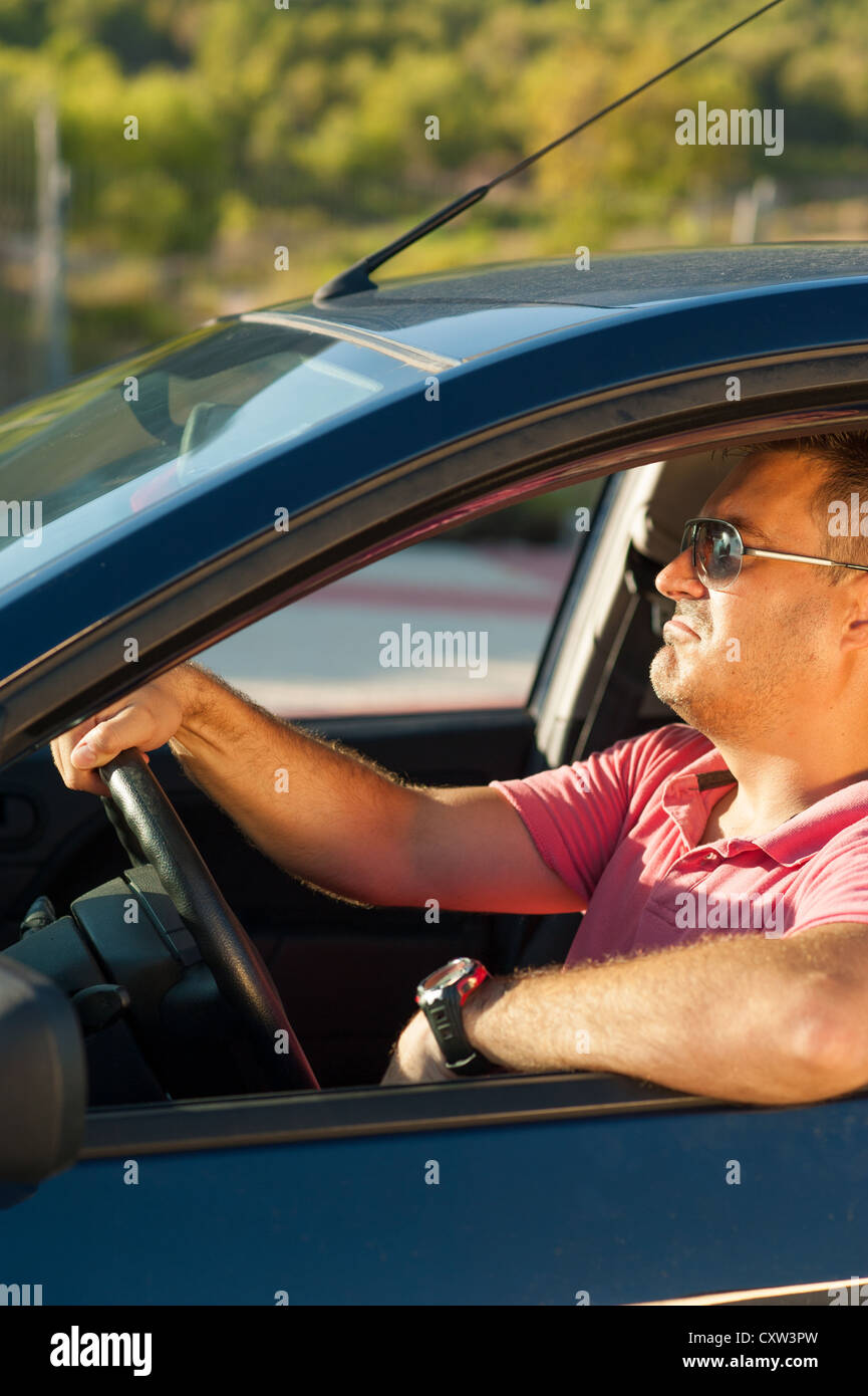 Male driver in a cool macho attitude Stock Photo - Alamy