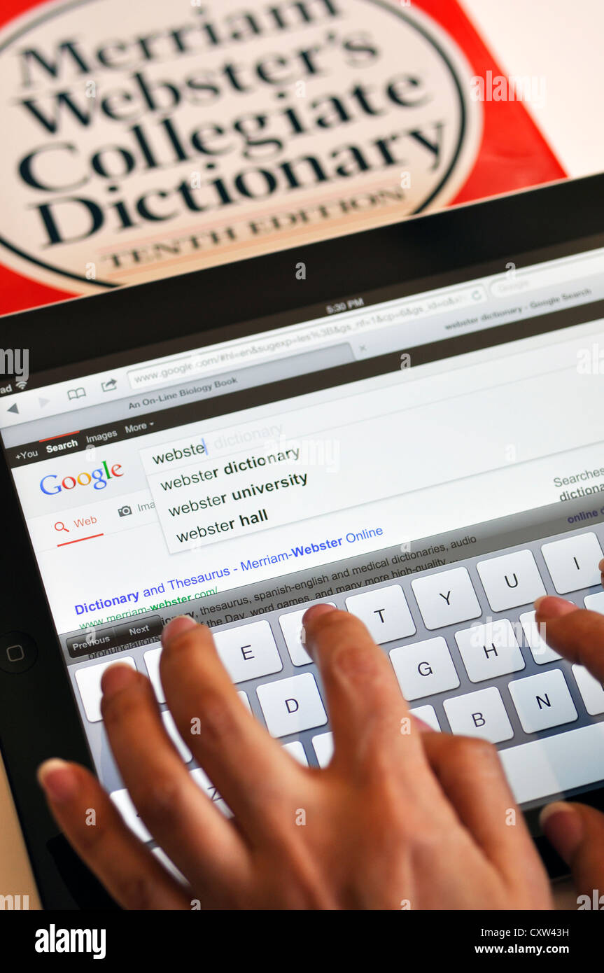 Webster Dictionary Google search on iPad and student typing Stock Photo ...