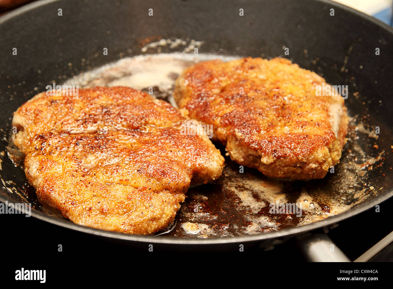 Schnitzel / cutlet in a pan Stock Photo - Alamy