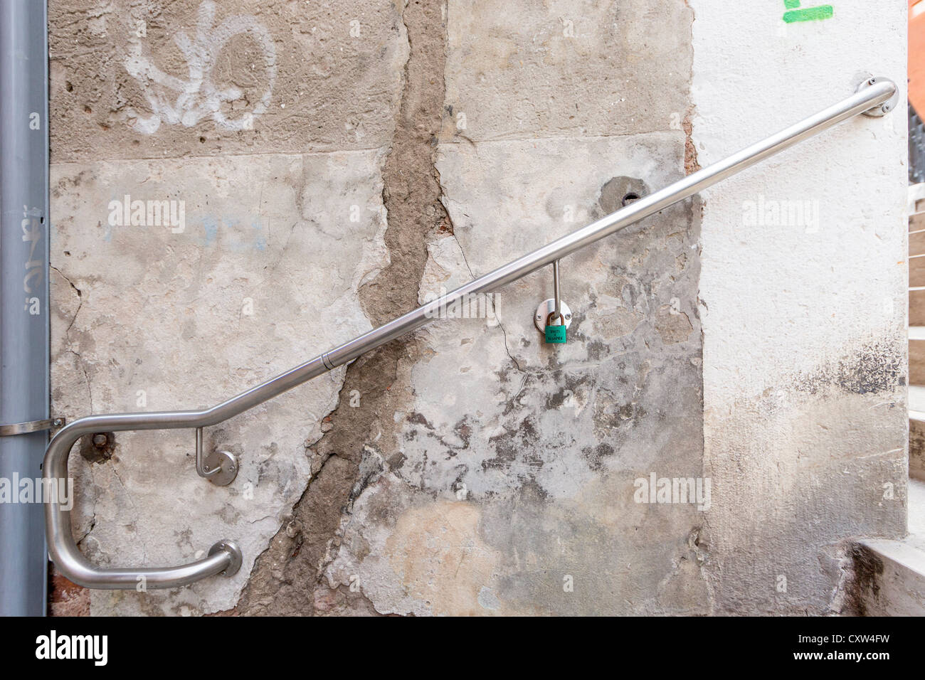 A green love padlock fixed to a handrail on a bridge in Venice ...