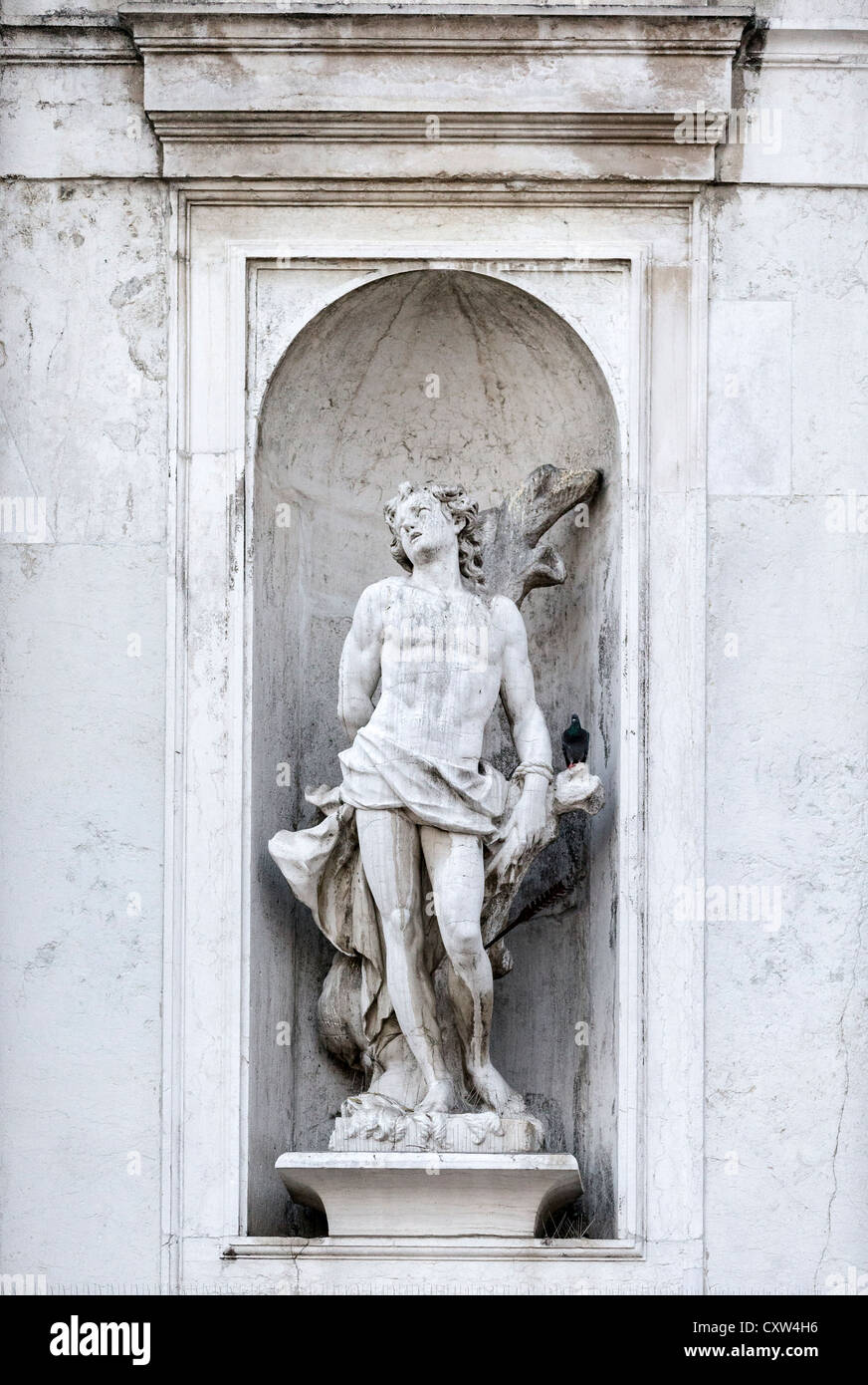 Carved stone statue of St Sebastian, martyred by being shot with arrows ...