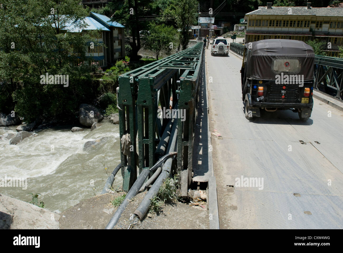 An auto rickshaw crosses a hazardous bridge in Manali, North India ...