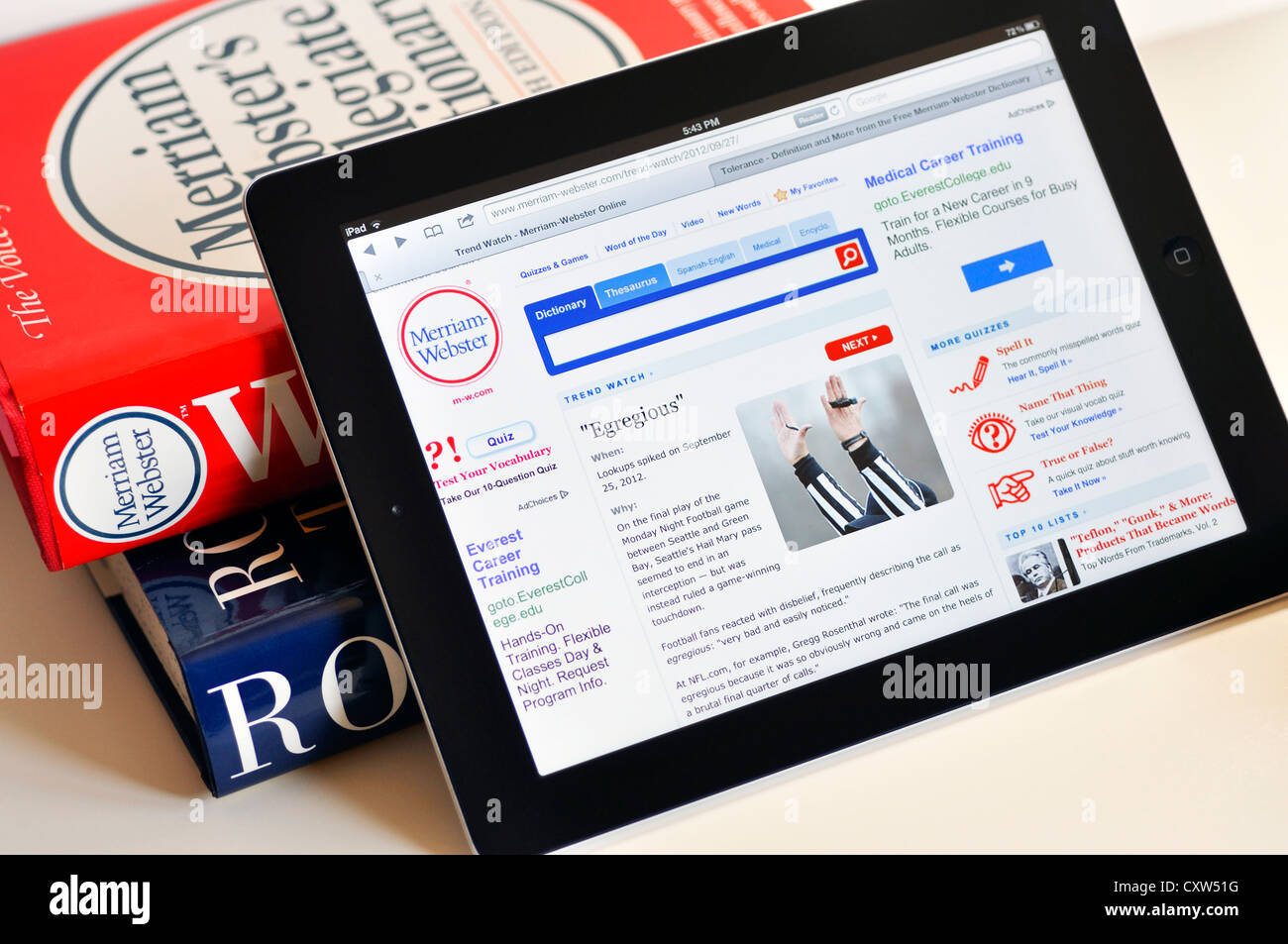 Webster Dictionary on iPad and a hard copy behind it Stock Photo - Alamy