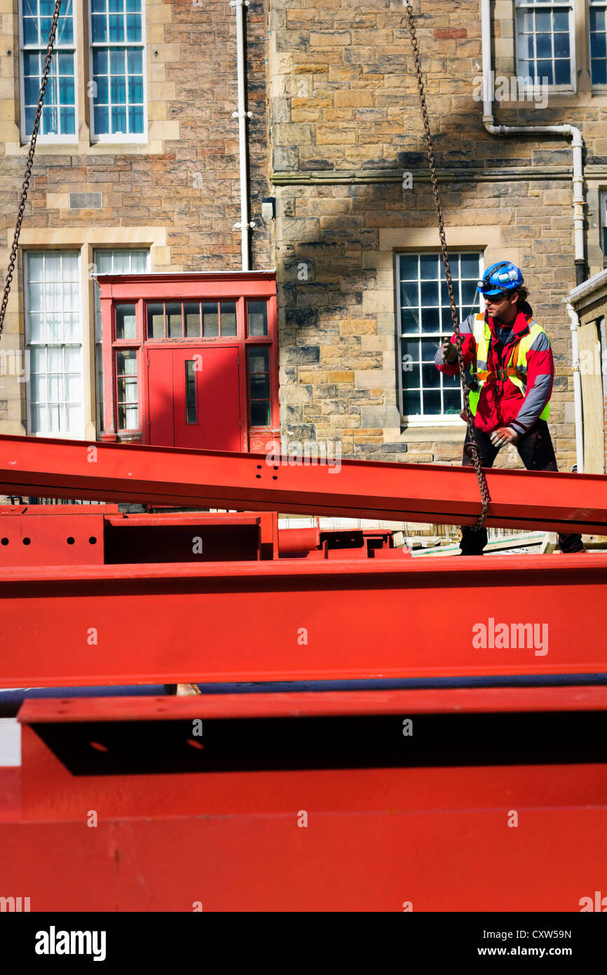Workman moving steels into position with help of overhead crane Stock ...