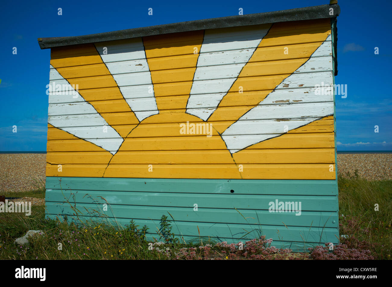 Small beach hut with a sun painted on its side New Romney Kent UK Stock ...