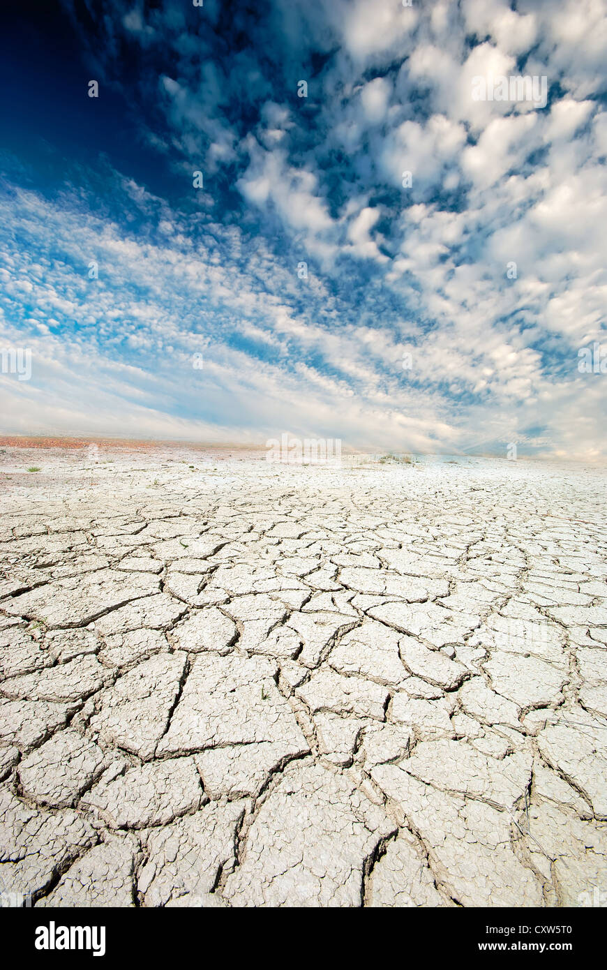 Cracked desert earth against the background sunset sky Stock Photo - Alamy