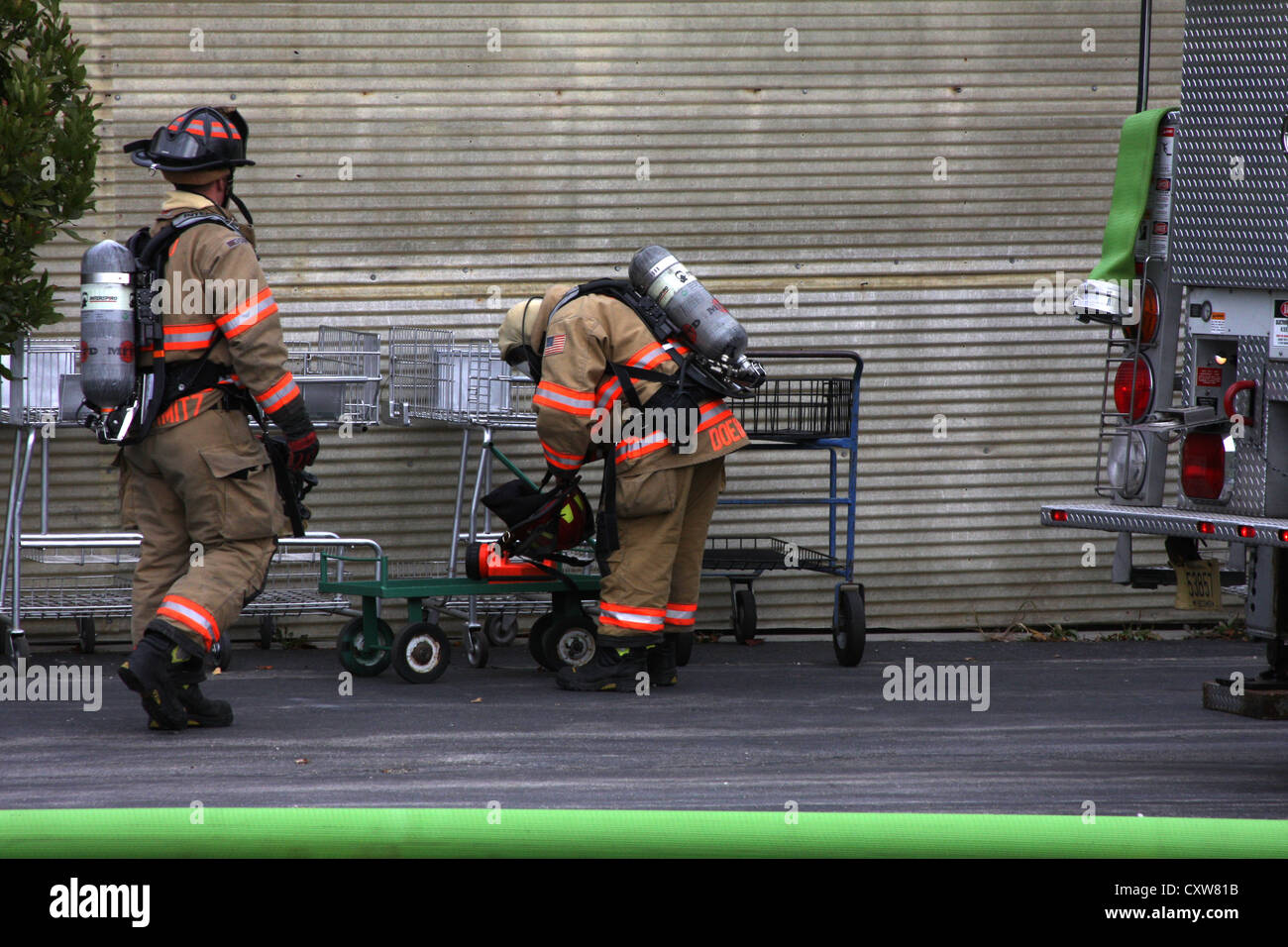 Two Firefighters suiting up for a fire call Stock Photo - Alamy