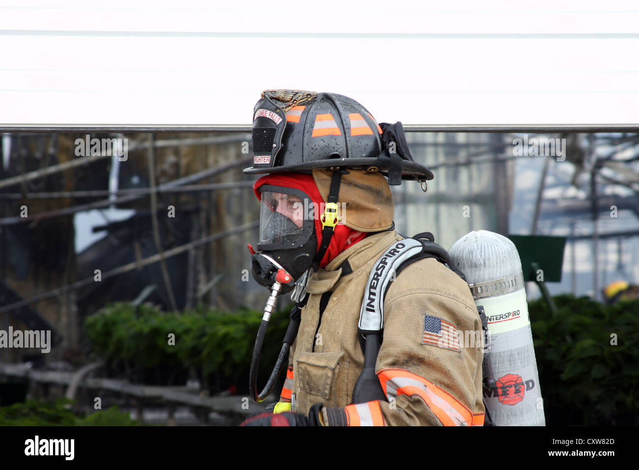 A firefighter at the scene of a fire in a greenhouse Stock Photo - Alamy