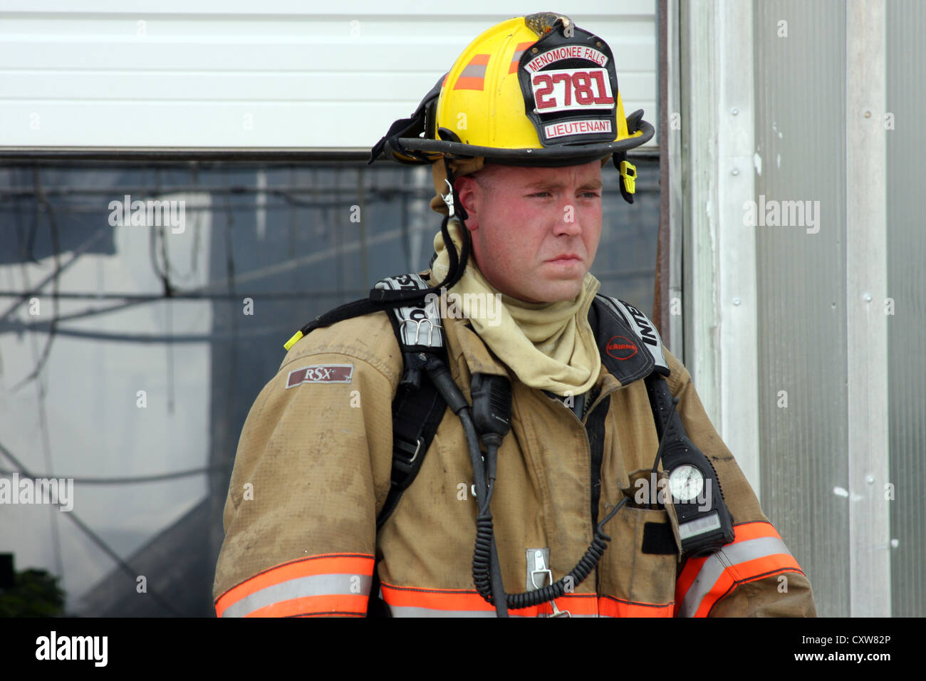 A firefighter at the scene of a greenhouse fire Stock Photo - Alamy