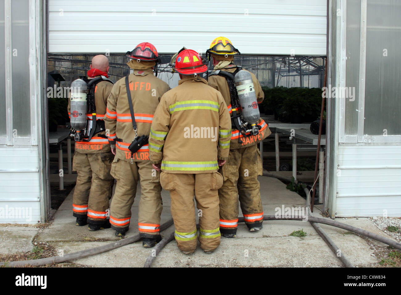 A group of firefighters discussing how to attack a fire scene Stock ...