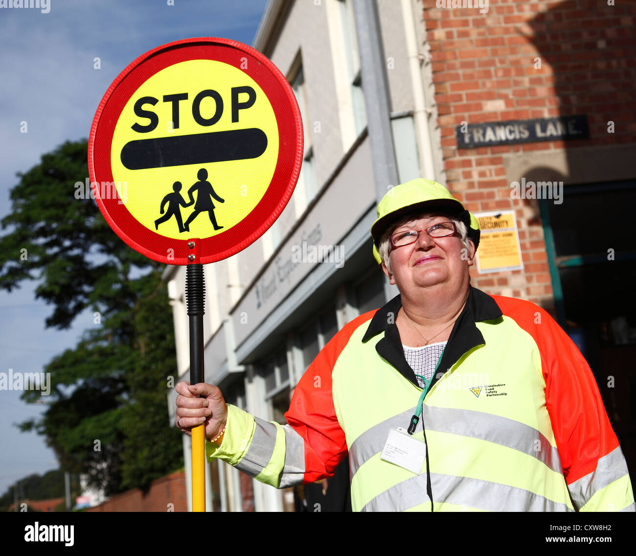 A lollipop lady on a school crossing patrol in the U.K Stock Photo - Alamy