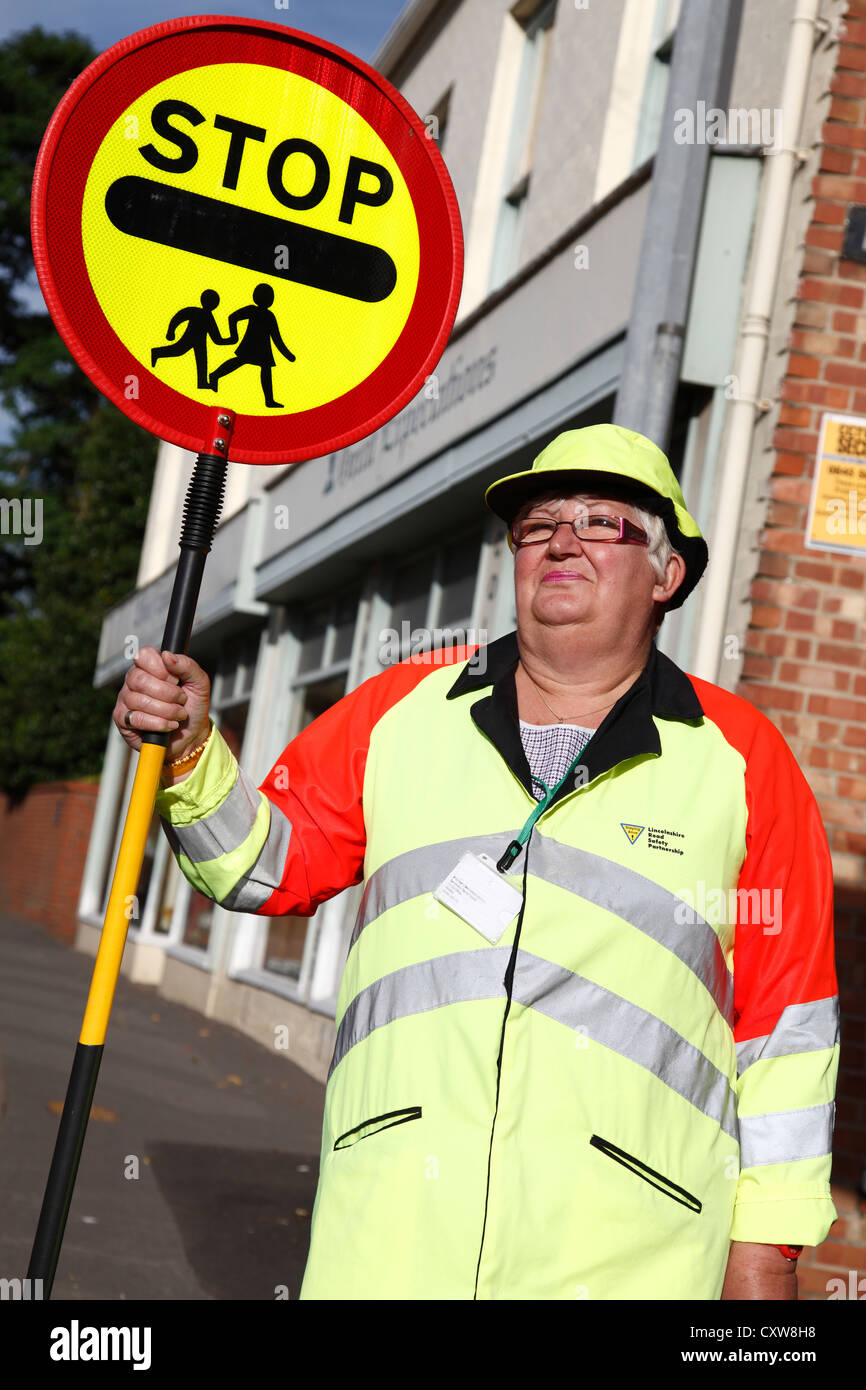 A lollipop lady on a school crossing patrol in the U.K Stock Photo - Alamy