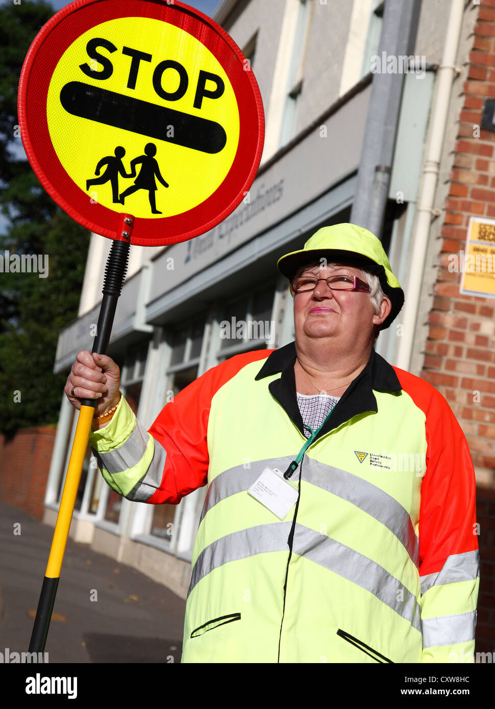 A lollipop lady on a school crossing patrol in the U.K Stock Photo - Alamy