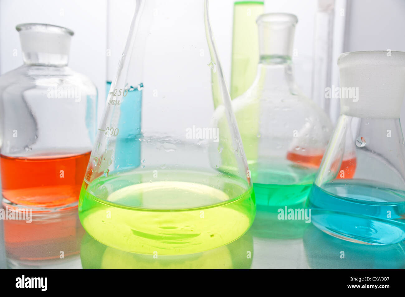 Laboratory glassware with various colored liquids Stock Photo - Alamy