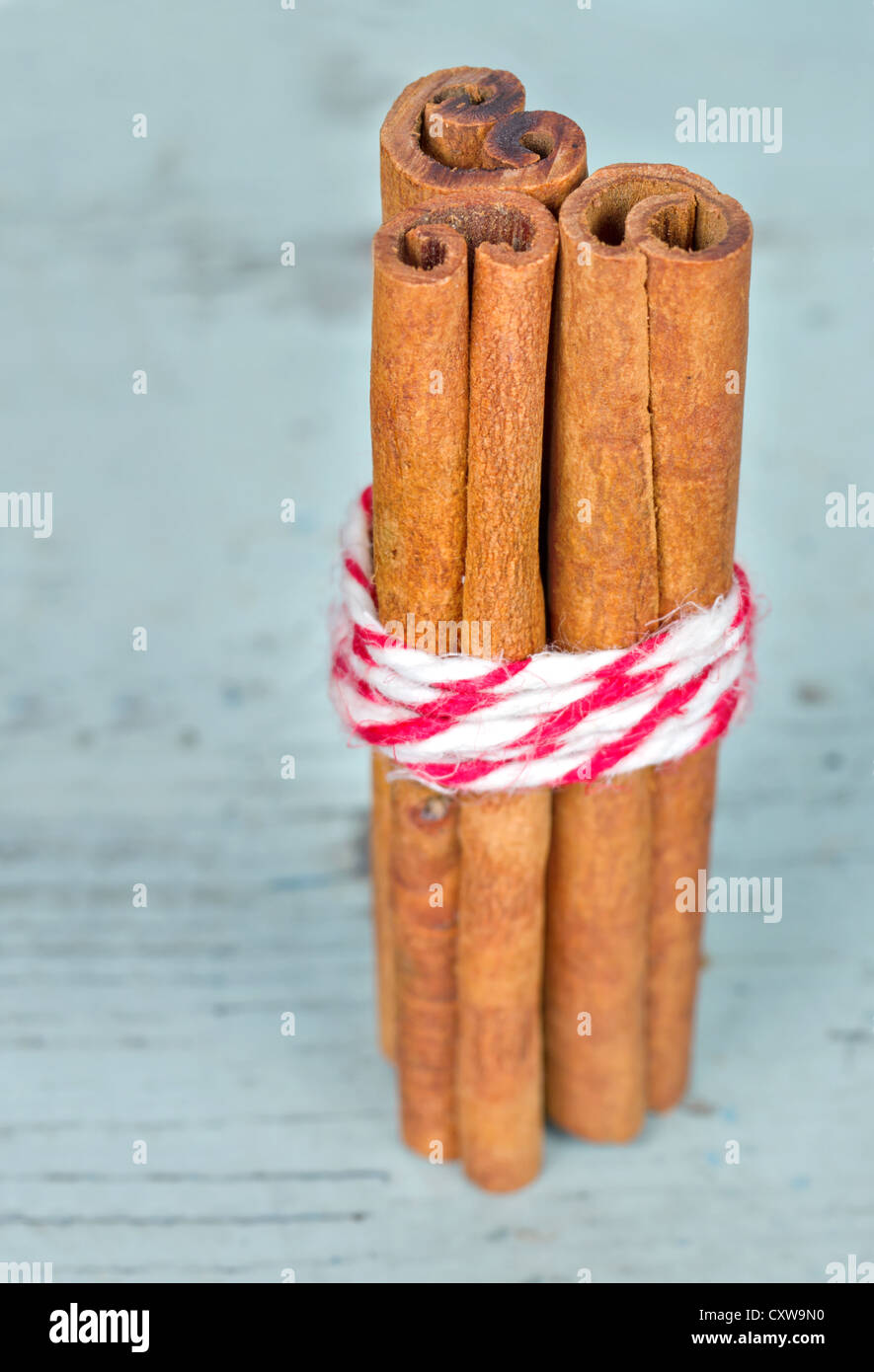 Bunch of cinnamon sticks on light blue wooden shabby chic background ...