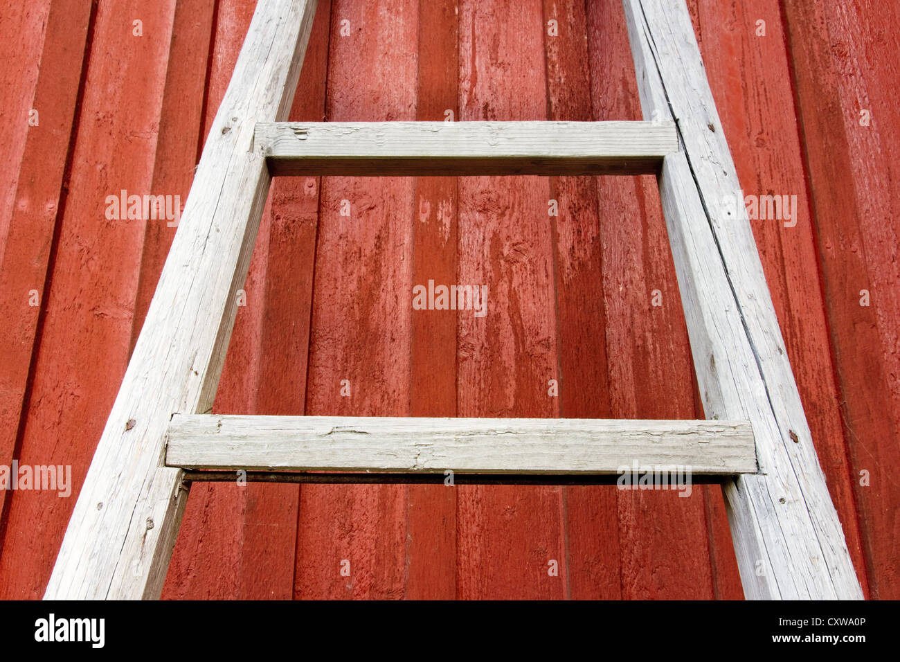 Rustic red wooden ladder reaching upwards Stock Photo - Alamy
