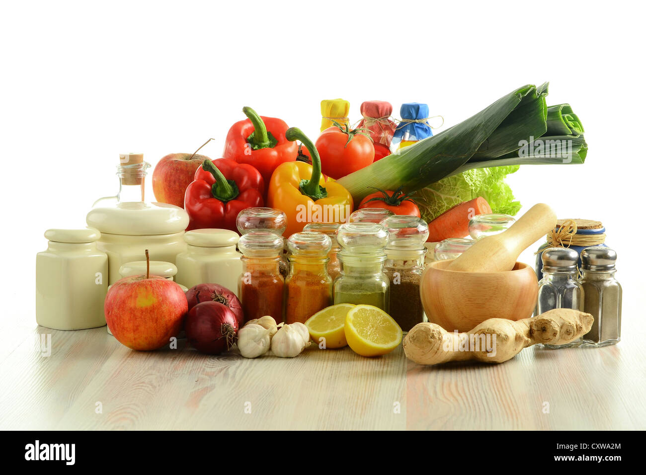 Composition with variety of spices and vegetables on kitchen table ...
