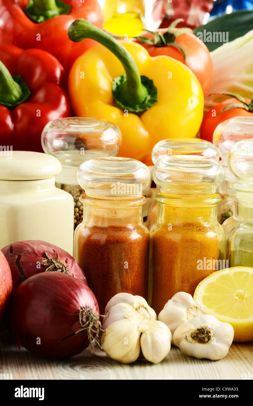Composition with variety of spices and vegetables on kitchen table ...