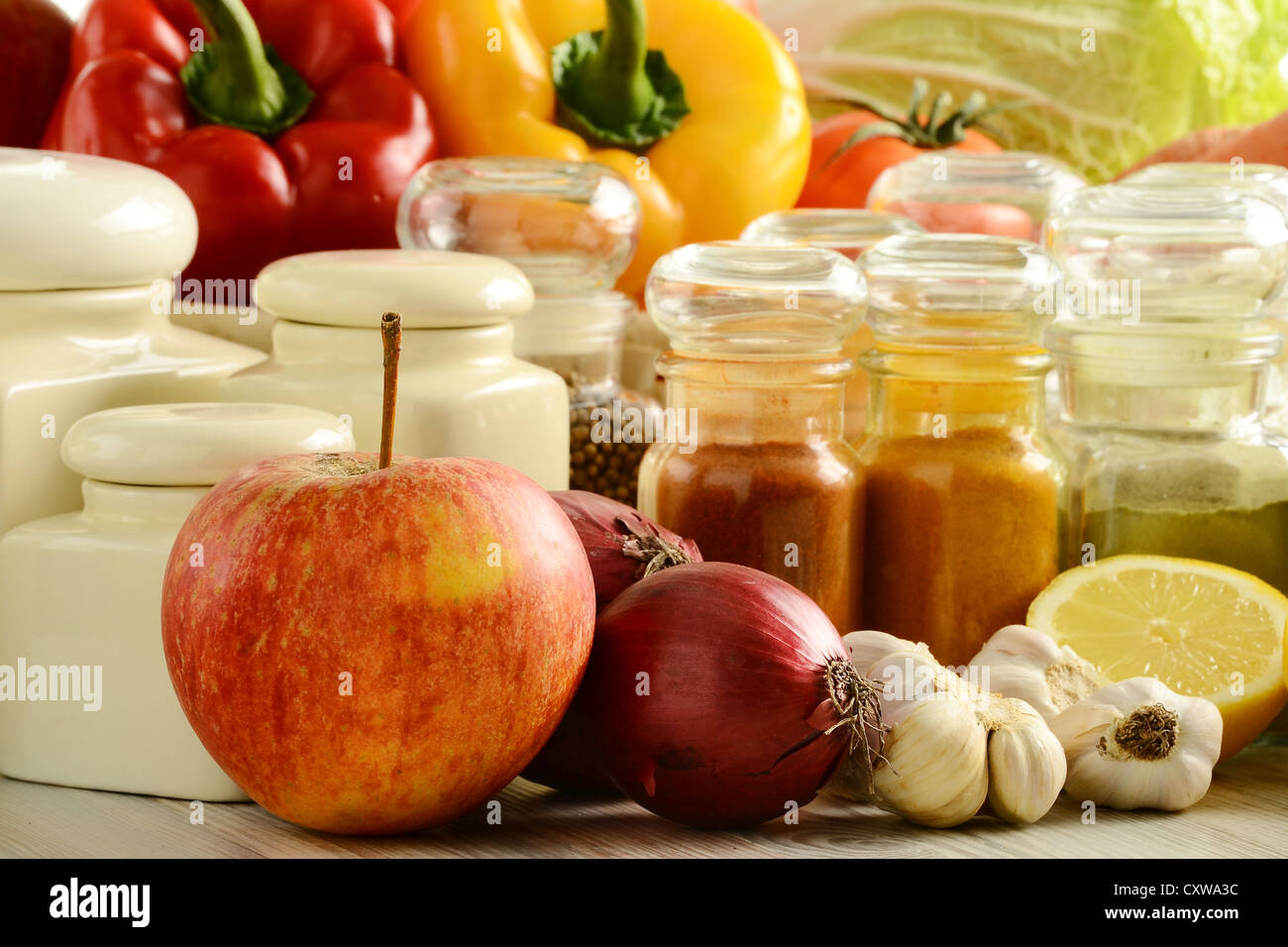 Composition with variety of spices and vegetables on kitchen table ...
