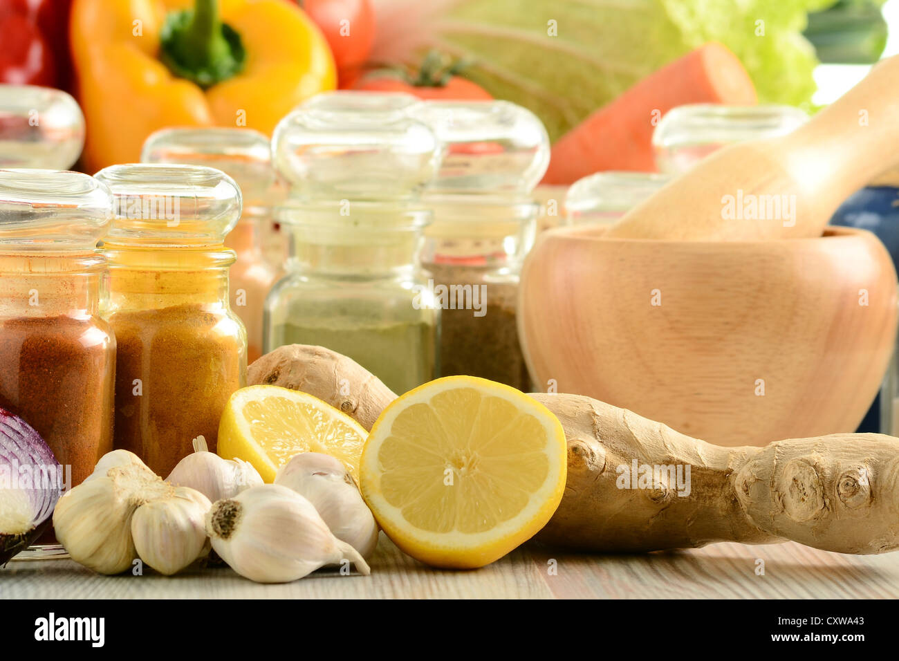 Composition with variety of spices and vegetables on kitchen table ...
