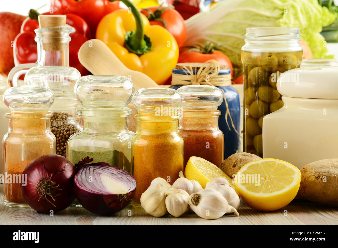 Composition with variety of spices and vegetables on kitchen table ...