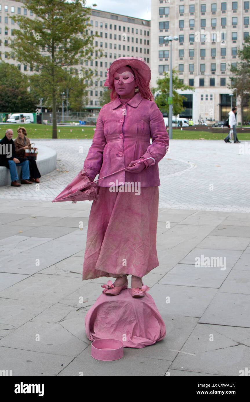 Pink lady living statue, Southbank street performer, London, UK Stock ...