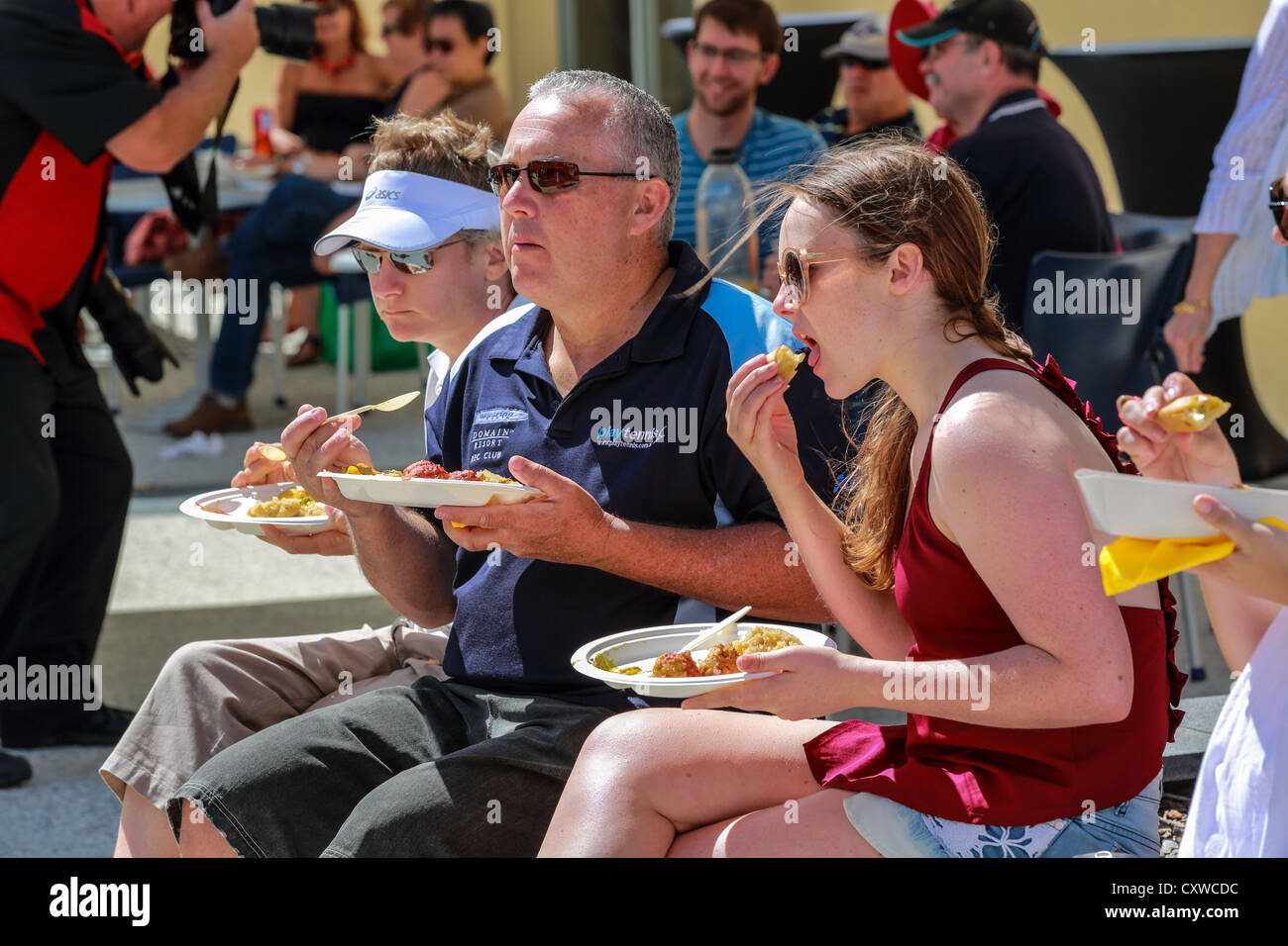 Audience eating at festival while watching dance troupe Stock Photo - Alamy