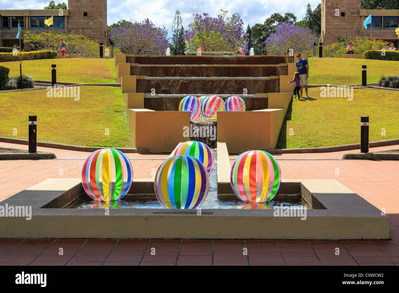Colourful inflated transparent balls float in a man made pond in a pond ...