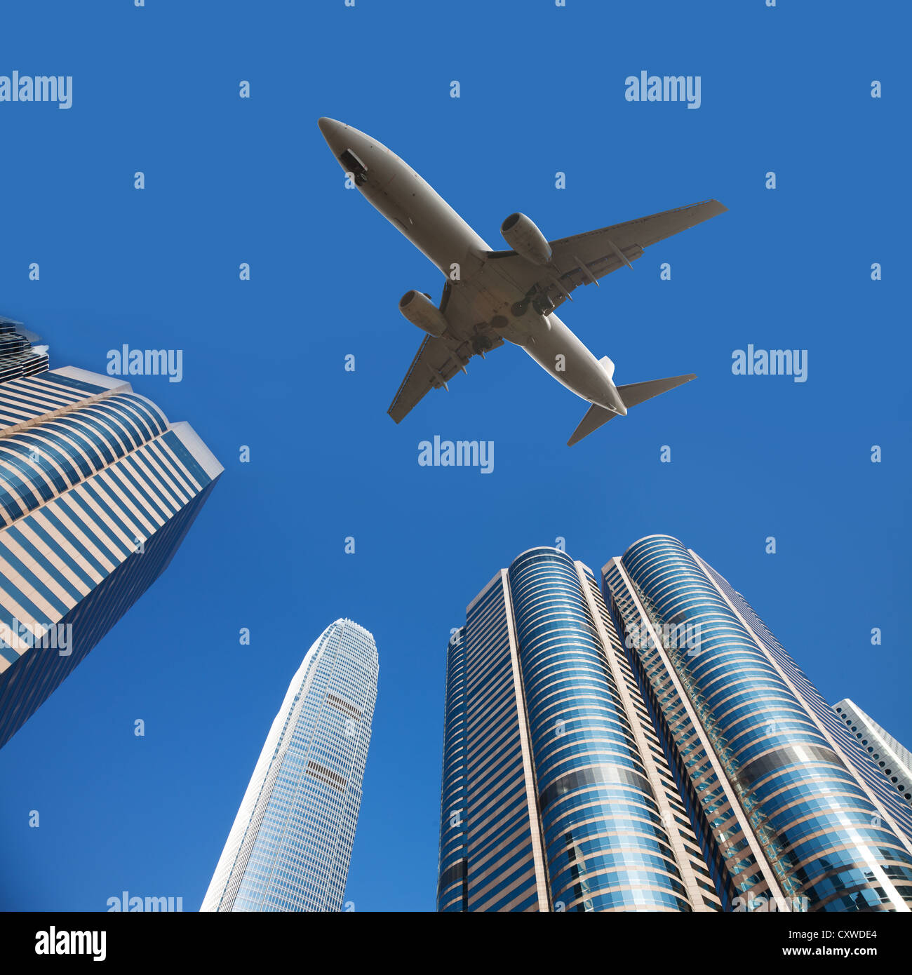 plane fly over modern city Stock Photo - Alamy