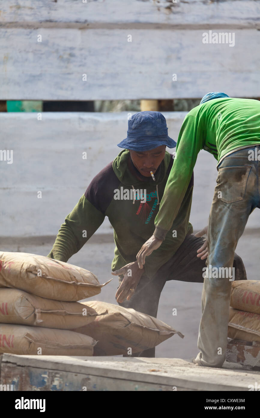 Workers unloading Cement Bags from a Ship in the Port Sunda Kalapa in ...