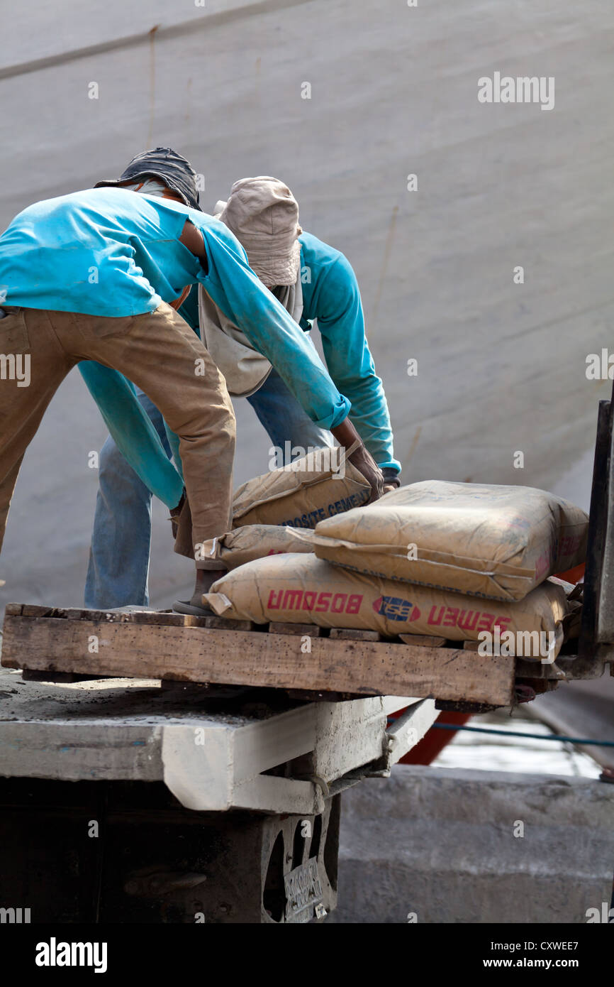 Workers unloading Cement Bags from a Ship in the Port Sunda Kalapa in ...
