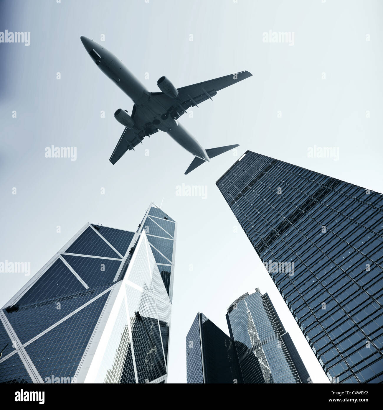 plane fly over modern city Stock Photo - Alamy