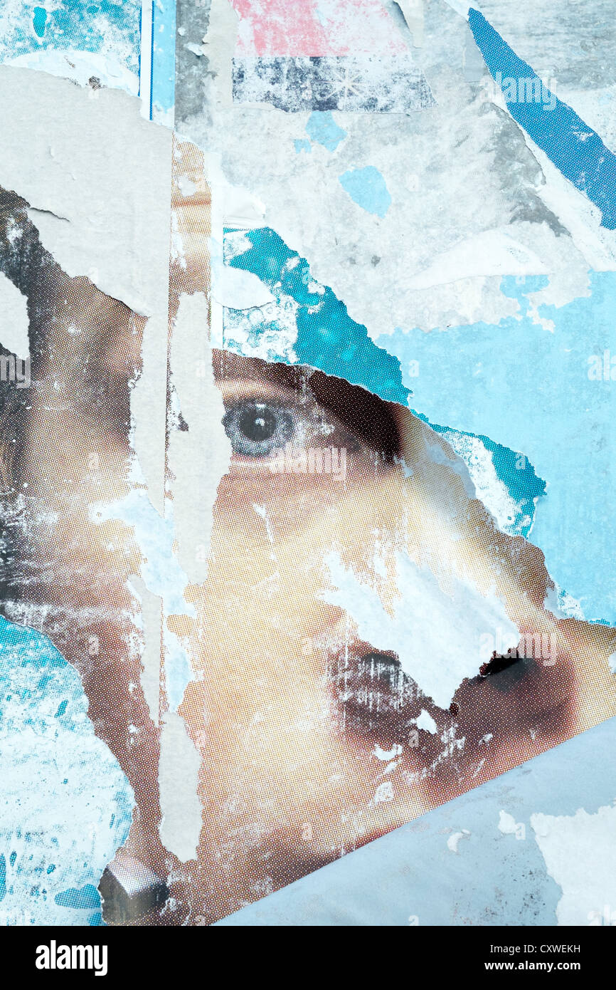 Section of torn and peeling bill board poster revealing a face ...