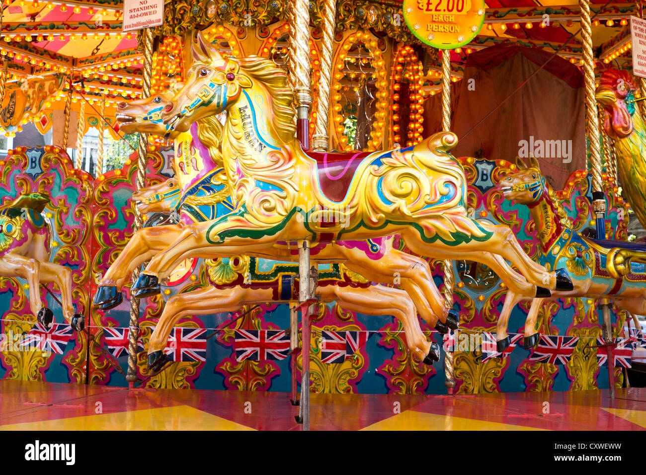 Colourful horses on a fairground merry go round ride Stock Photo - Alamy