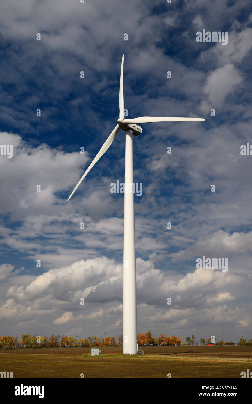 Wind power turbine electricity generation on farm field with white ...
