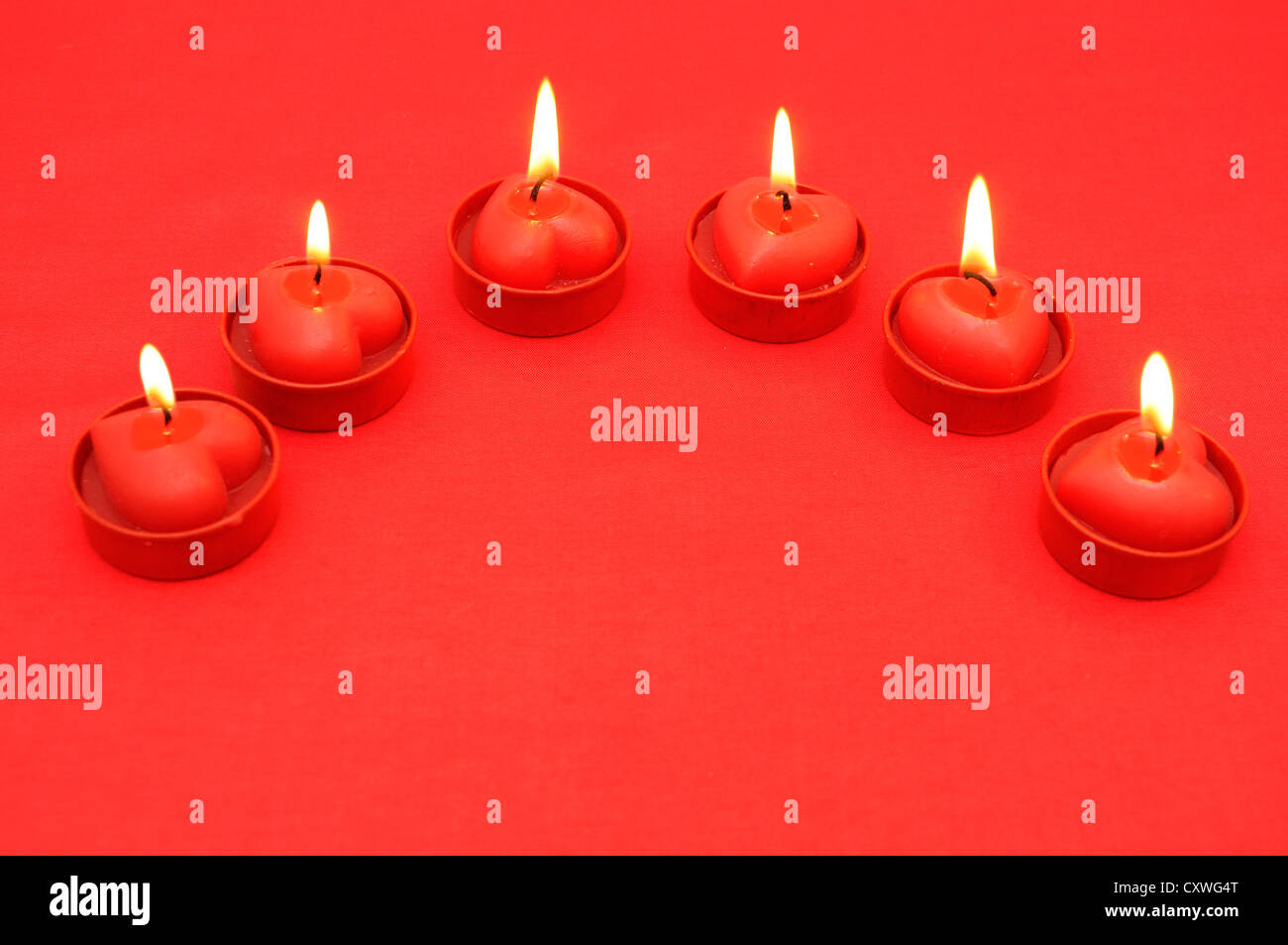 Background of red silk drape and six flaming candles Stock Photo - Alamy