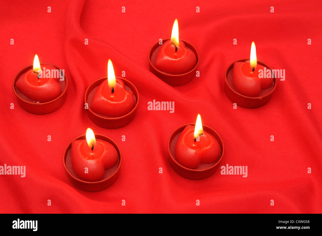 Background of red silk drape and six flaming candles Stock Photo - Alamy