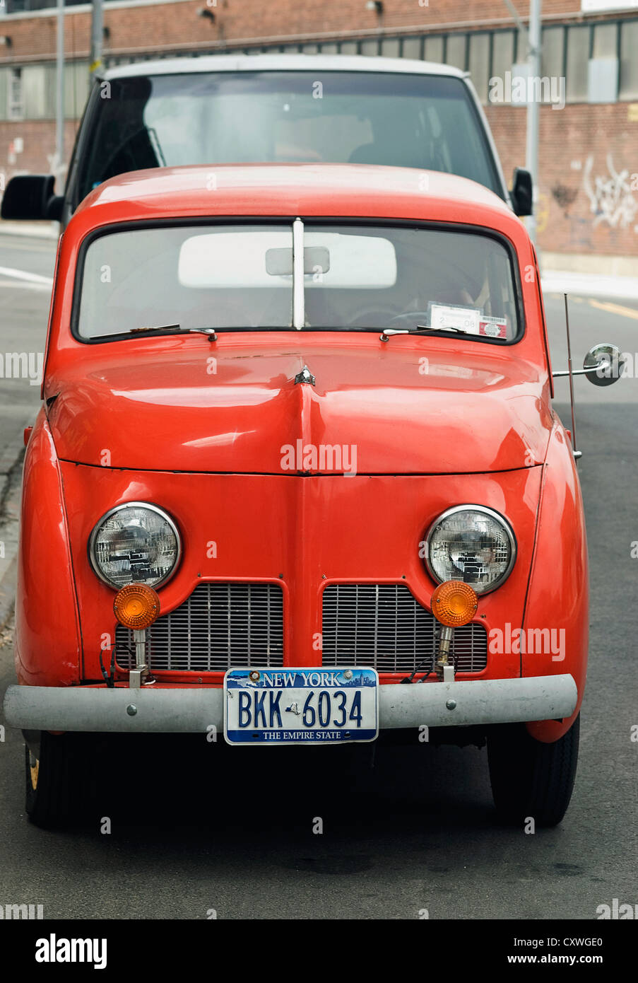 A funky little red car parked on a side street in Brooklyn, New York ...