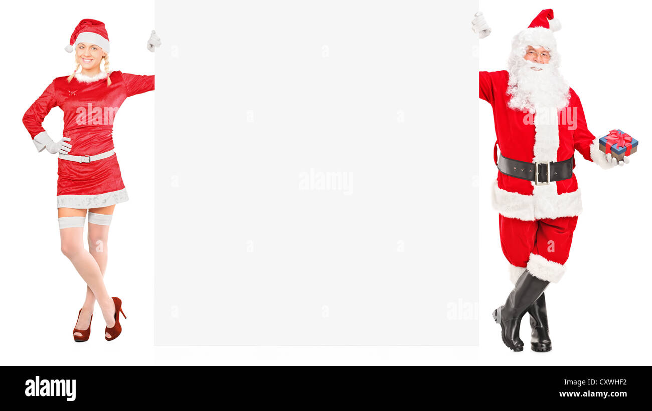 Full length portrait of a female and male Santa Clauses holding a white ...