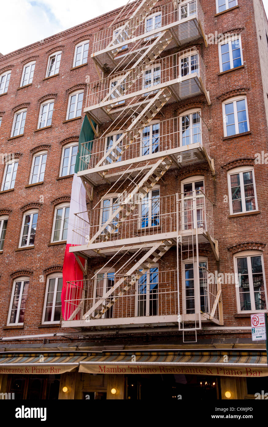 Restored tenement building in Little Italy with large Italian flag ...