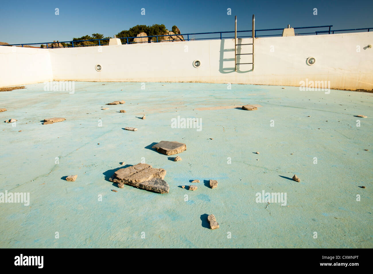 A derelict swimming pool at an abandoned holiday complex in Myrina on ...