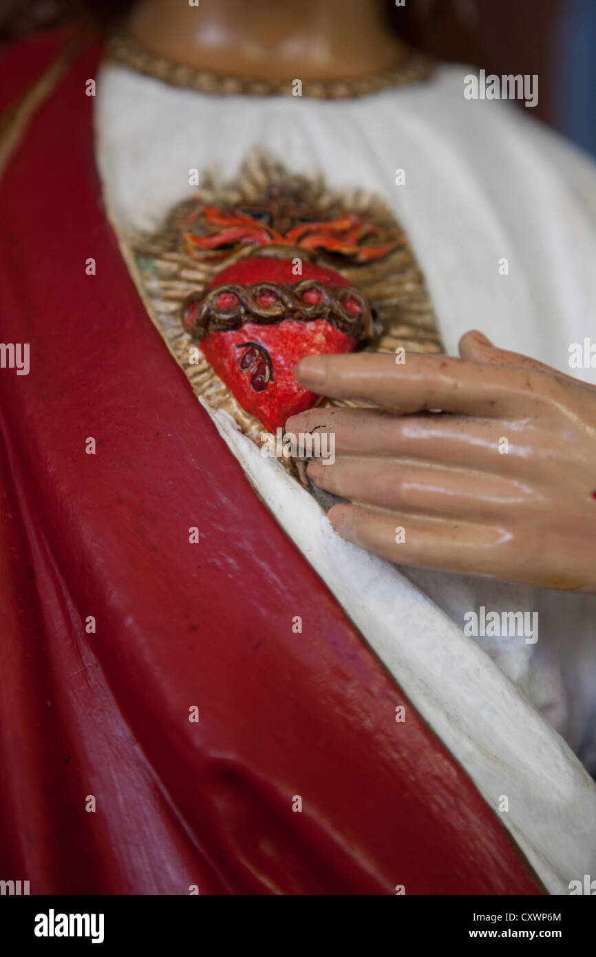Closeup of statue of Jesus pointing to his heart Stock Photo - Alamy