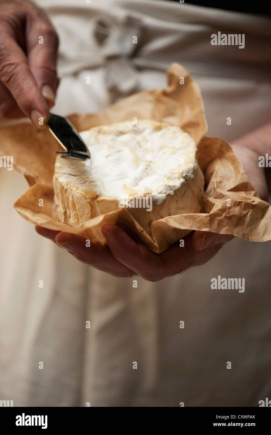 Close up of man slicing cheese Stock Photo - Alamy