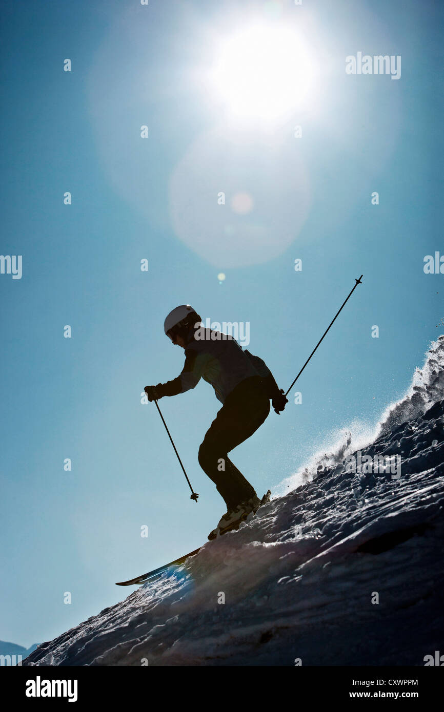 Skier coasting on snowy slope Stock Photo - Alamy
